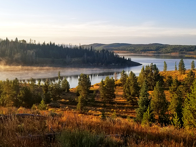 Morning mist rises from Steamboat Lake like nature's own special effect, painting the autumn landscape in gold that would make Midas envious.