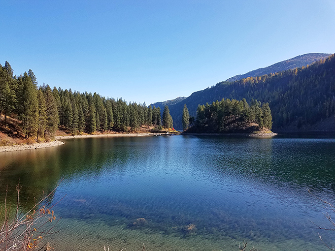 Mirror-perfect waters reflect towering pines at Farragut State Park, where Mother Nature clearly spent extra time on the landscaping.