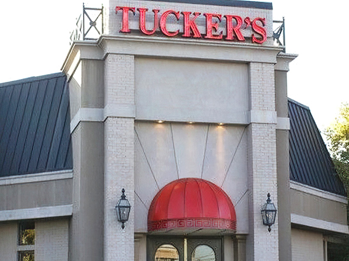 Tucker's iconic red signage stands out like a culinary lighthouse, beckoning hungry travelers with promises of comfort food paradise.