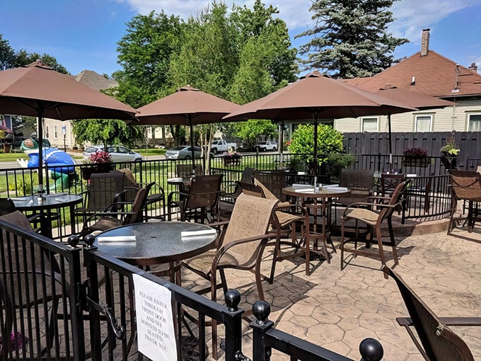Outdoor paradise awaits! Brown umbrellas stand guard over comfortable patio seating, perfect for those Ohio summer evenings when dining al fresco feels like a small vacation.