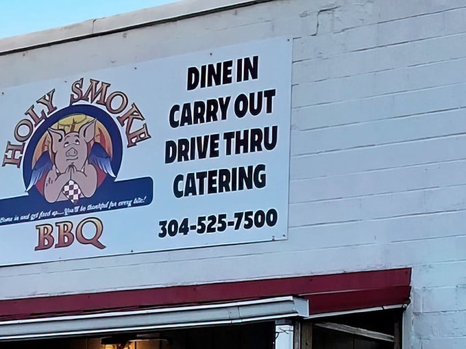 The Holy Smoke BBQ sign promises salvation for hungry travelers – a white-walled temple of smoked meat with a cheerful pig mascot guiding the way.