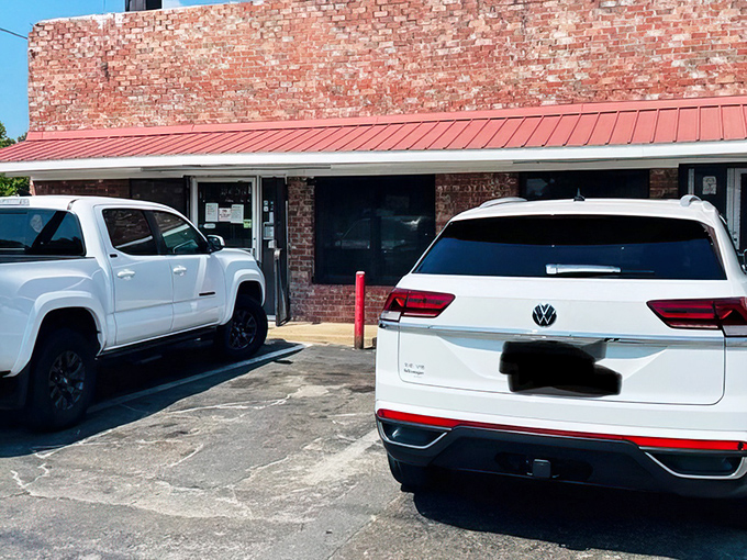 The unassuming brick exterior of E&L Barbeque&mdash;where culinary magic happens behind walls that have absorbed decades of heavenly smoke.