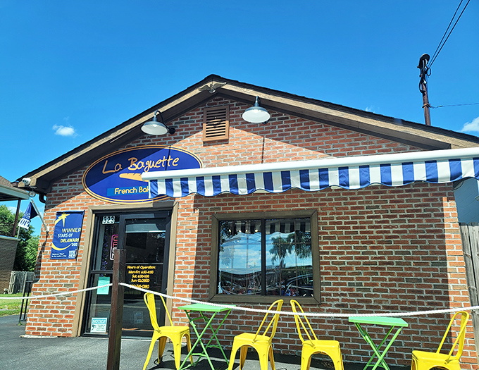 The blue and gold sign beckons like a lighthouse for carb enthusiasts, promising French delights behind that unassuming brick facade.