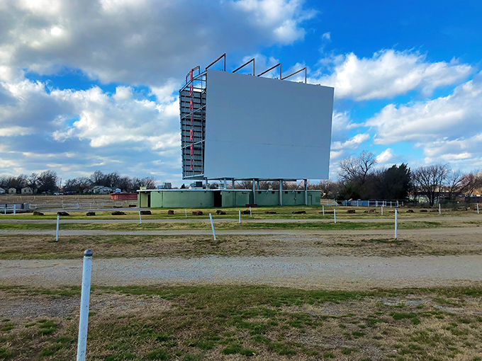 Clouds drift above the towering screen like nature's own opening credits, promising an evening of entertainment under the vast Oklahoma sky.