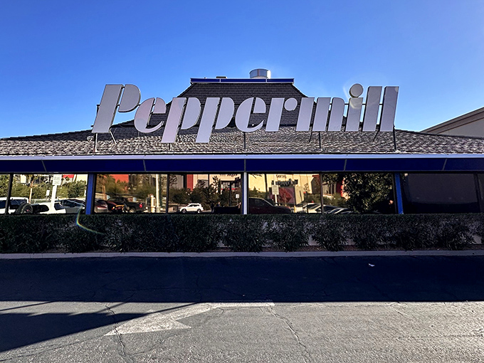 The iconic Peppermill sign stands proud against the Vegas sky, like a neon beacon calling to hungry travelers and locals alike.