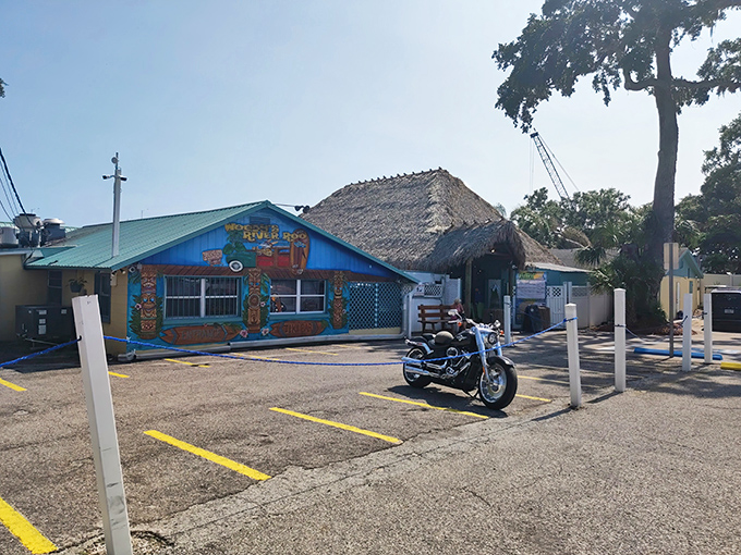 The bright turquoise exterior of Woody's River Roo announces itself like a tropical mirage, promising cold drinks and good times before you even park.