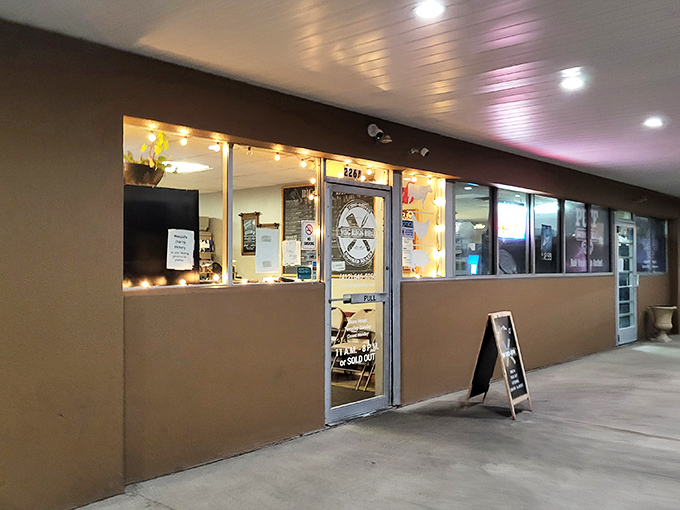 The storefront windows offer a tantalizing preview of the smoky treasures waiting inside this unassuming strip mall gem.