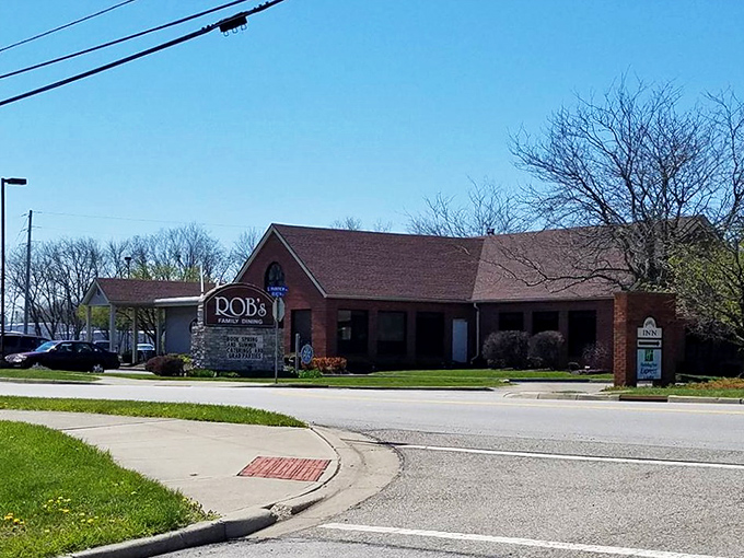 The restaurant's sign peeks out among vibrant day lilies, like a culinary lighthouse guiding flavor-seekers through a sea of chain restaurants.