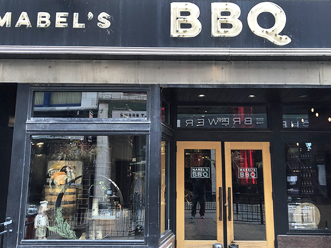 The unassuming storefront of Mabel's BBQ stands like a beacon of smoky promise on Cleveland's East 4th Street, those golden doors practically beckoning meat lovers inside.