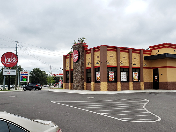The iconic red and tan exterior of Jack's in Eufaula stands like a beacon of comfort food promise, its stone tower proudly announcing: good things await inside.