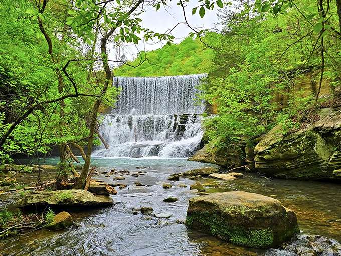 Nature's perfect curtain call &ndash; Mirror Lake Waterfall cascades in tiers of white froth, framed by vibrant green foliage that seems to applaud its performance.
