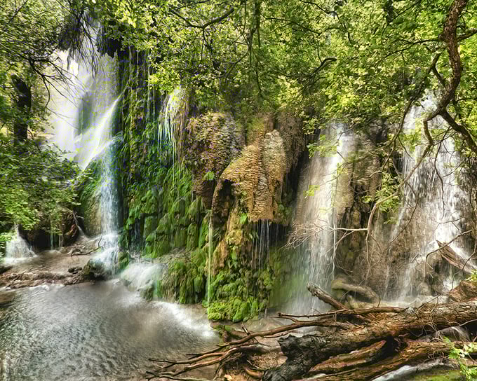 Nature's own masterpiece cascades down moss-covered limestone like something from a fairy tale.