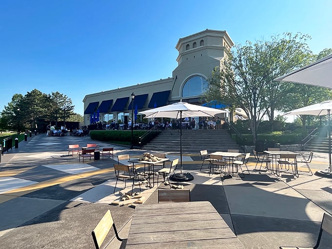 Newport Grill's elegant stone exterior with blue awnings creates an unexpected coastal oasis in the heart of landlocked Kansas.