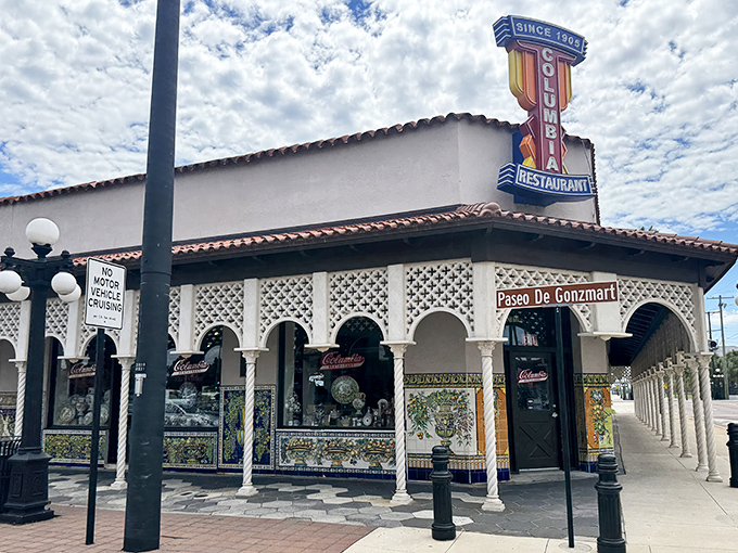 The iconic Columbia Restaurant sign stands proudly against Florida's blue sky, a beacon of Spanish culinary tradition in Ybor City since 1905.