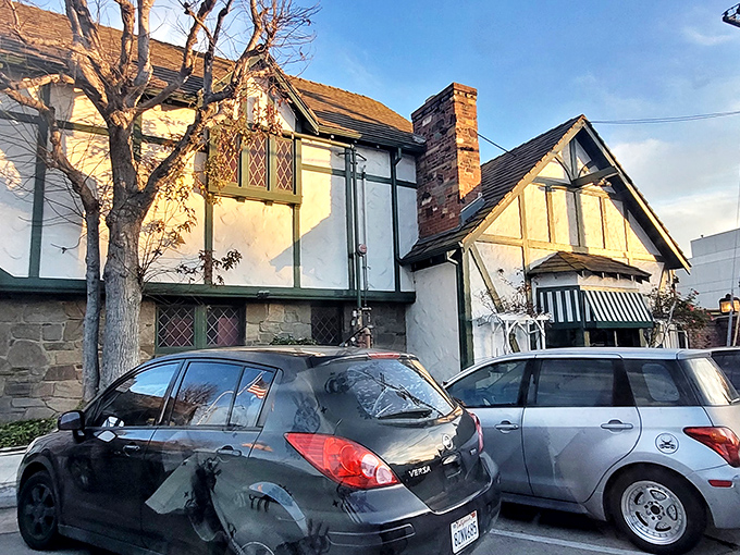 The Tudor-style exterior of Smoke House stands as a time capsule of old Hollywood charm, promising culinary nostalgia before you even step inside.