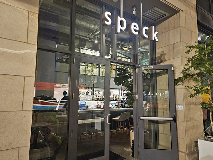 Minimalist elegance greets you at Speck's entrance, where that simple sign promises culinary adventures far more complex than its four-letter name suggests.