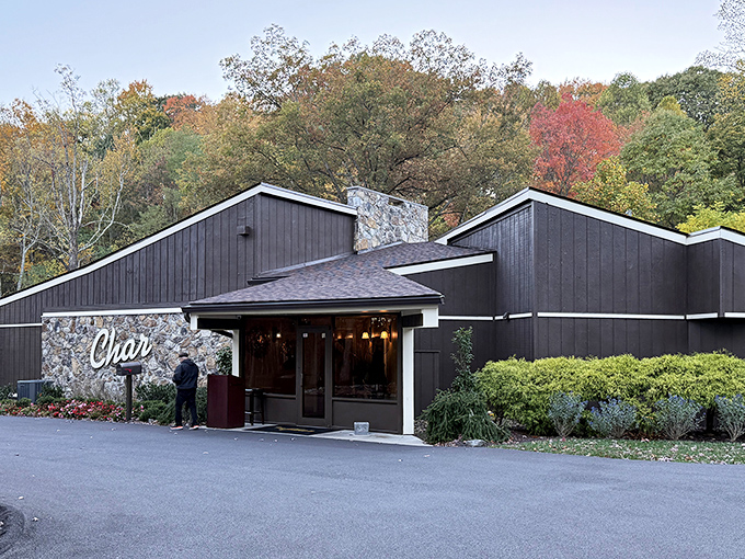 The Char's distinctive dark timber exterior with stone accents stands out against West Virginia's autumn foliage &ndash; mountain dining with unexpected coastal flair inside.