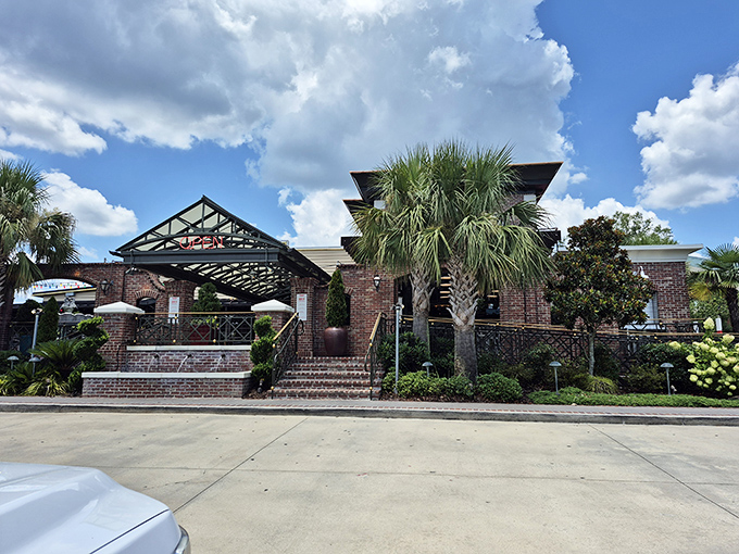 The brick exterior with palm trees and covered entrance isn't just inviting&mdash;it's practically waving you in with the promise of Cajun delights inside.