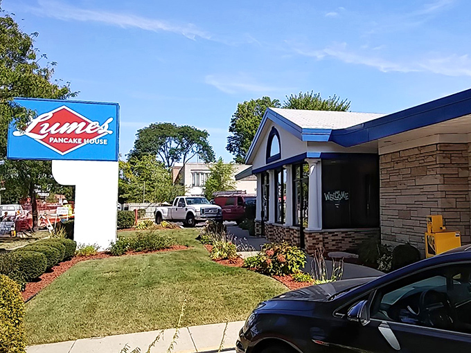 The iconic blue and red Lumes sign welcomes hungry patrons like a breakfast lighthouse guiding you to pancake paradise.