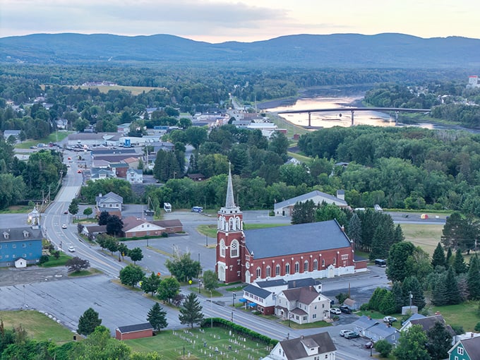 Fort Kent from above, where the church steeple stands as the town's exclamation point against a backdrop of rolling hills and river views.