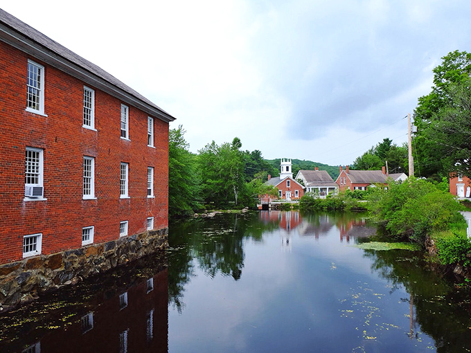 Historic red brick mills reflecting in Harrisville Pond &ndash; a scene so perfect it makes you wonder if Mother Nature moonlights as a professional photographer.
