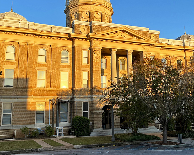 The Clay County Courthouse basks in golden hour sunlight, its stately brick facade and dome standing as the crown jewel of Ashland's downtown. Small-town grandeur at its finest.