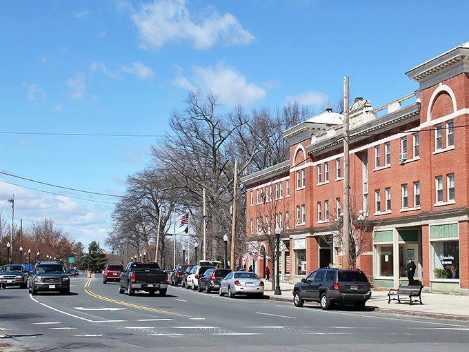 Downtown Ludlow's historic brick buildings stand as proud sentinels of small-town charm, where Massachusetts history meets modern-day bustle under brilliant blue skies.