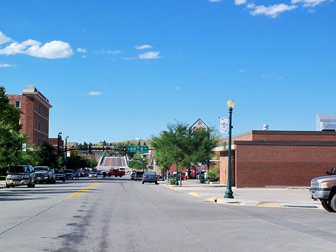 Main Street Lusk stretches toward the horizon like a scene from a Norman Rockwell painting, where brick buildings and blue skies create the perfect small-town tableau.