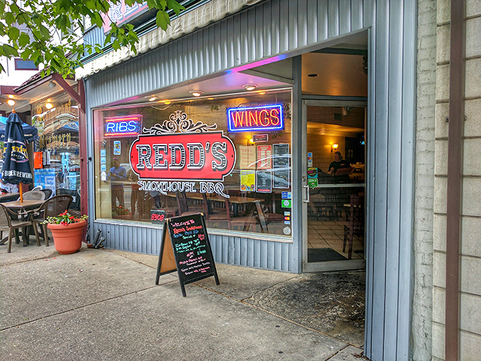 The neon-lit promise of Redd's Smokehouse BBQ beckons from downtown Carlisle, a siren song for smoked meat enthusiasts everywhere.