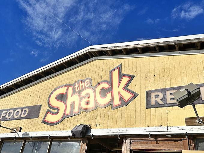 That iconic yellow sign against the blue Florida sky promises seafood treasures within &ndash; no buried chest required.