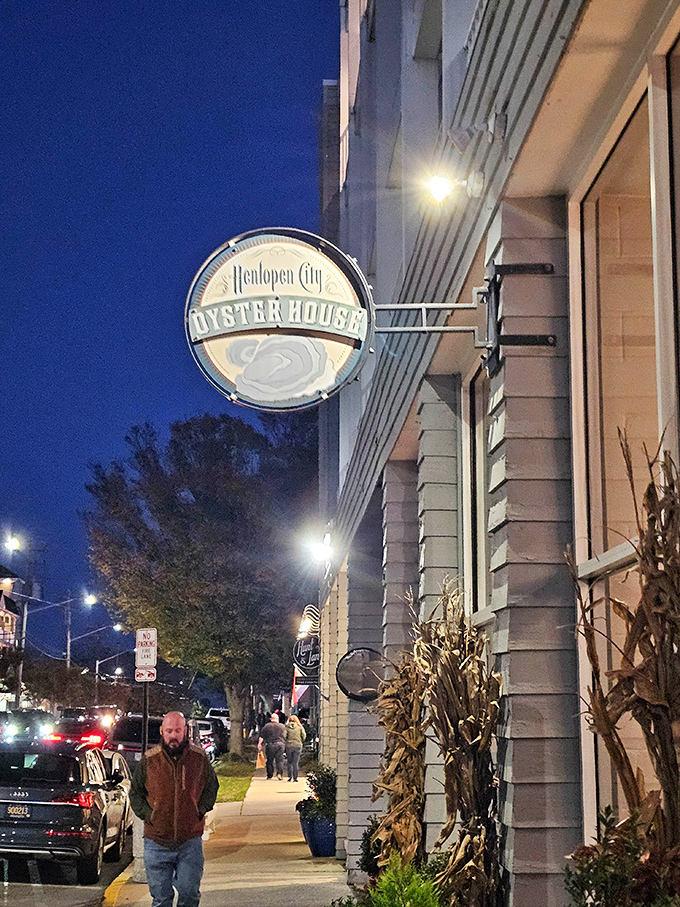 The iconic Henlopen City Oyster House sign glows like a beacon against the twilight sky, promising seafood salvation just steps from Rehoboth's bustling boardwalk.