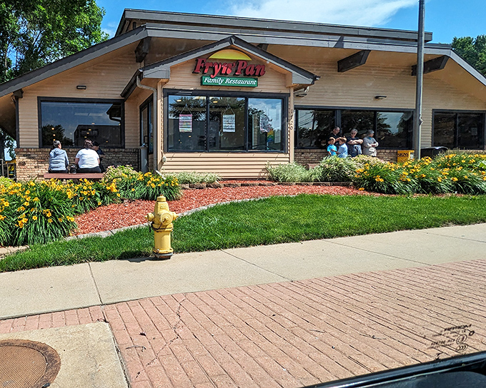 The Fryn' Pan's welcoming exterior promises comfort food salvation with its distinctive peaked roof and cheerful landscaping. Like a beacon for the breakfast-deprived traveler.