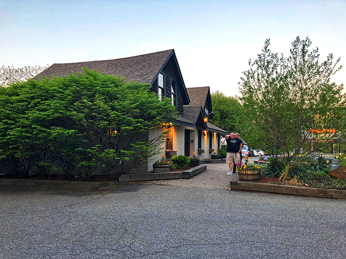Vermont charm meets barbecue heaven at Bluebird's inviting exterior. Hydrangeas and string lights welcome you to this shingled sanctuary of smoke and flavor.