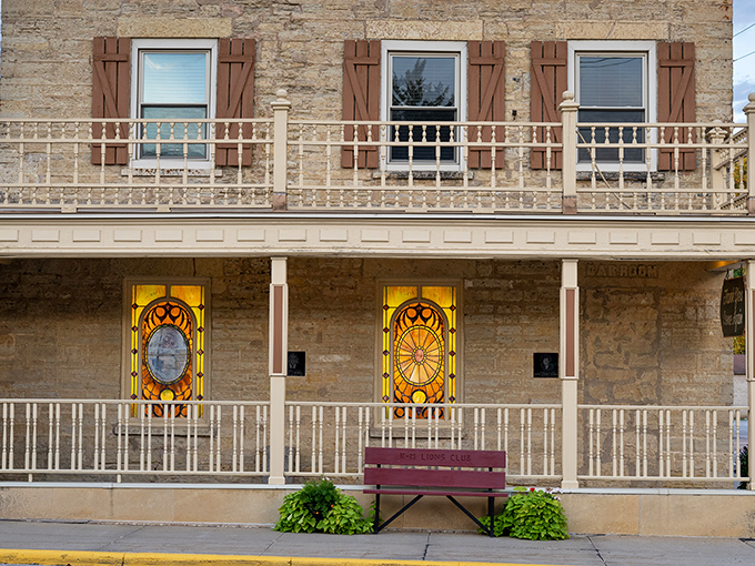 The historic limestone facade of Hubbell House stands like a sentinel of culinary history, its stained glass windows glowing with the promise of memorable meals within.