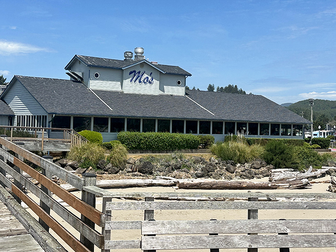 Mo's iconic white clapboard exterior stands like a coastal sentinel, promising seafood treasures within. The blue sign has guided hungry travelers for generations.