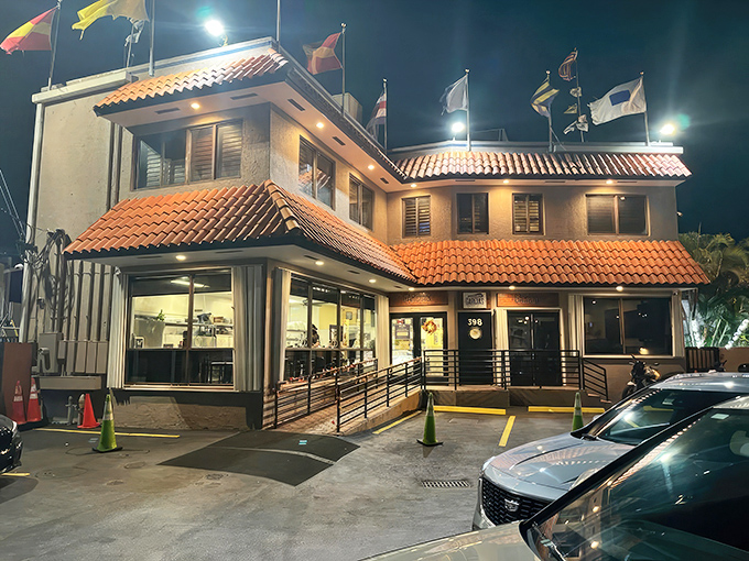 Garcia's Spanish-influenced exterior glows warmly at night, its terracotta roof and colorful flags beckoning seafood lovers like a maritime lighthouse.