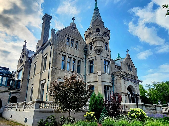 The castle's limestone façade gleams in the sunlight, its turrets and gables standing proudly against the Minnesota sky like a European postcard come to life.