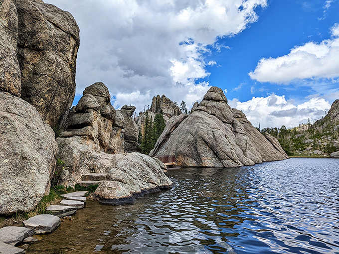 Sylvan Lake's granite sentinels stand guard over crystal waters, creating nature's perfect infinity pool. Step across those stones and enter another world entirely.