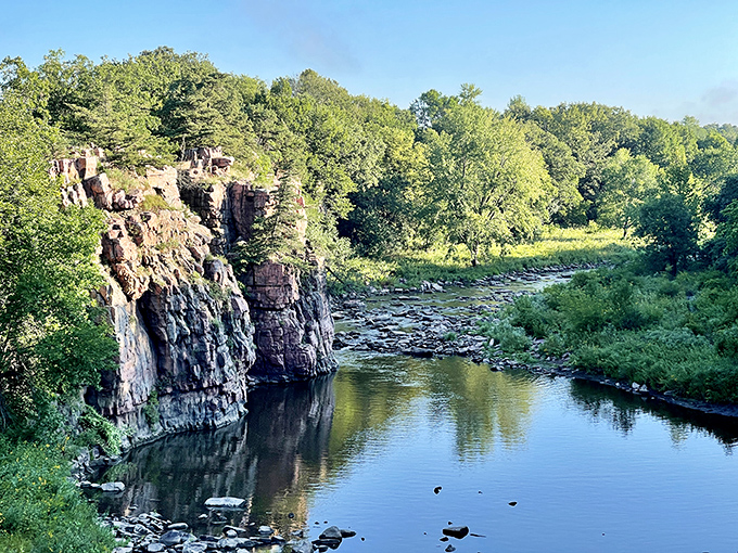 Nature's skyscraper complex! These billion-year-old quartzite cliffs reflect perfectly in Split Rock Creek, creating South Dakota's most impressive natural mirror selfie.