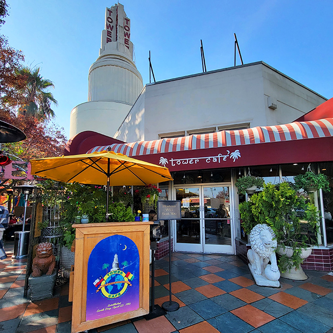 Bathed in California sunshine, Tower Cafe's distinctive architecture stands as a Sacramento landmark where global flavors meet local charm under striped awnings.