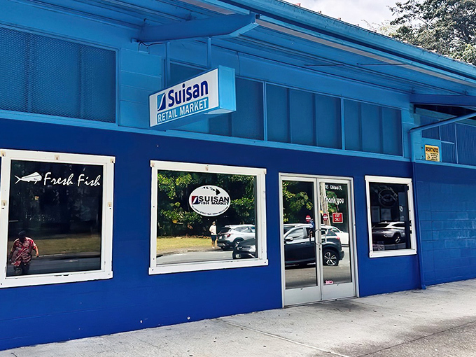 The iconic blue exterior of Suisan Fish Market stands like a beacon for seafood lovers in Hilo.