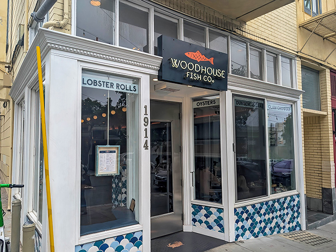 The maritime charm begins before you even step inside, with Woodhouse Fish Co.'s distinctive blue-and-white fish scale tiles framing a storefront that practically shouts "lobster rolls inside!"