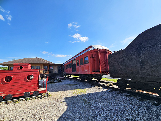 All aboard the flavor express! The bright red Buckeye Express Diner sits majestically on a grassy hill, with a vintage locomotive keeping it company.