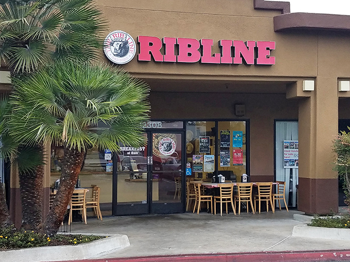 The unassuming storefront of Rib Line beckons with its bold red signage and palm trees. BBQ paradise doesn't always need fancy digs to deliver extraordinary flavor.