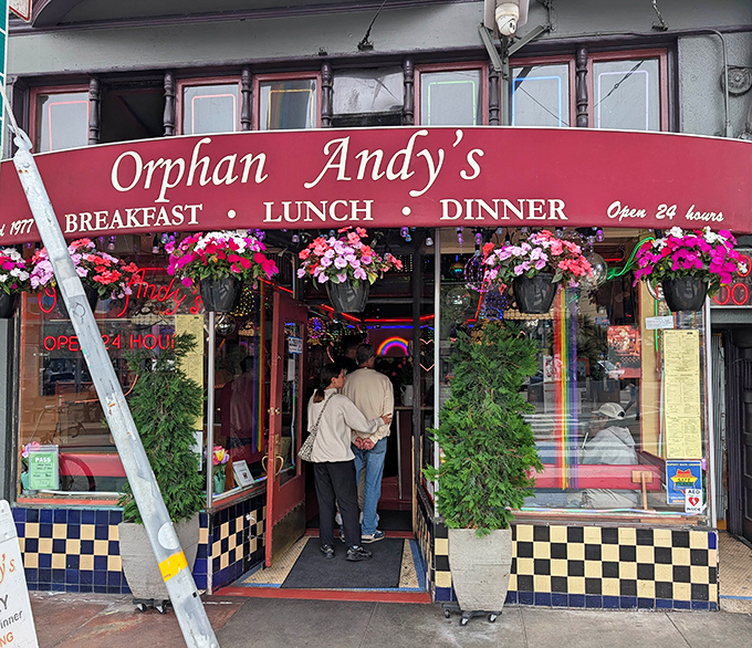That red awning calls to you like a siren song, promising comfort food and zero judgment about ordering breakfast at midnight.
