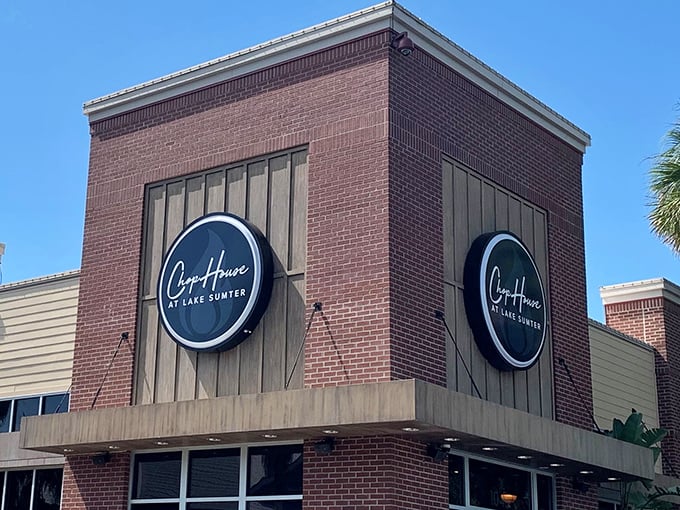 The brick facade of Chop House at Lake Sumter stands like a culinary fortress, promising delicious treasures within. Those circular signs aren't just for show—they're beacons for hungry travelers.