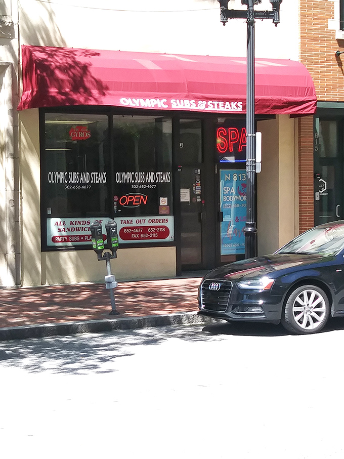 The iconic red awning of Olympic Subs & Steaks stands out like a culinary lighthouse on North Market Street, beckoning hungry Wilmingtonians to sandwich paradise.