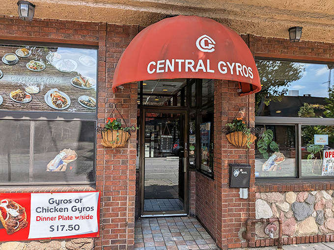 This charming brick facade with its distinctive red tile roof whispers promises of Mediterranean magic waiting inside.