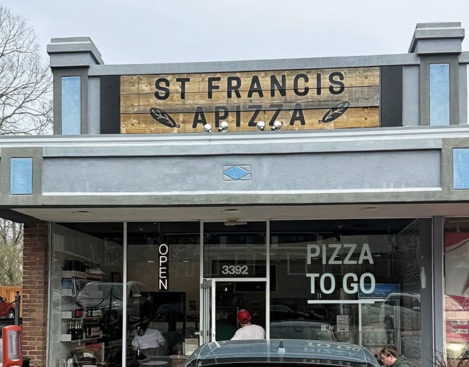 That wooden sign isn't just decoration&mdash;it's a beacon for pizza lovers, signaling that behind these modest doors lies New Haven-style pizza perfection in Cincinnati.