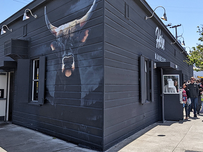 The black building with that magnificent bull mural isn't just making a statement&mdash;it's making a promise about what awaits inside.